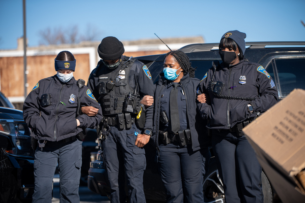 Western District Baltimore Police Officers lock arms in prayer with the ...