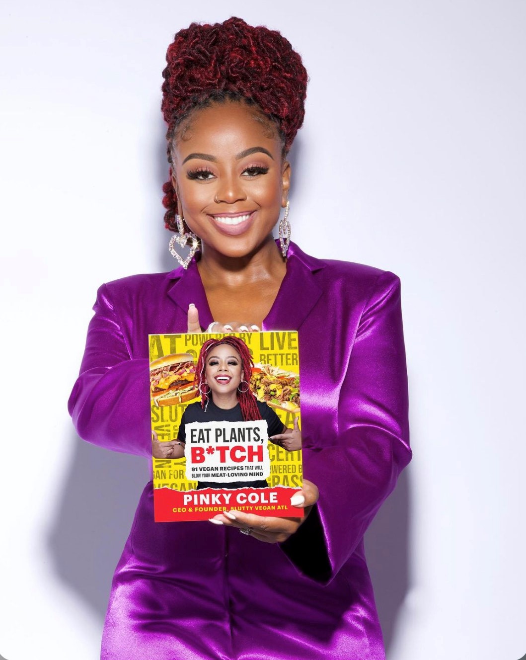 Pinky-Cole-w-book_Cred.-Drea-Nicole-Photography | AFRO American Newspapers